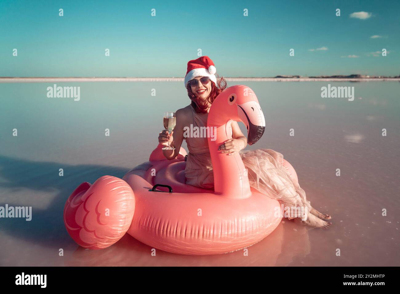 Santa Flamingo Christmas woman Riding Inflatable Flamingo Pink Lake. A ...