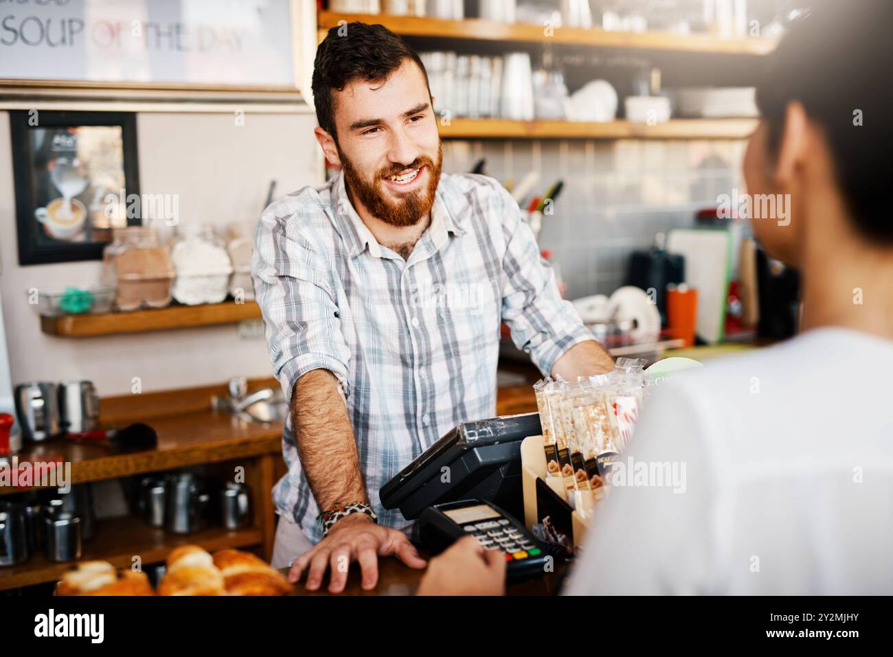 Coffee shop, counter and man with customer for service, checkout and ...
