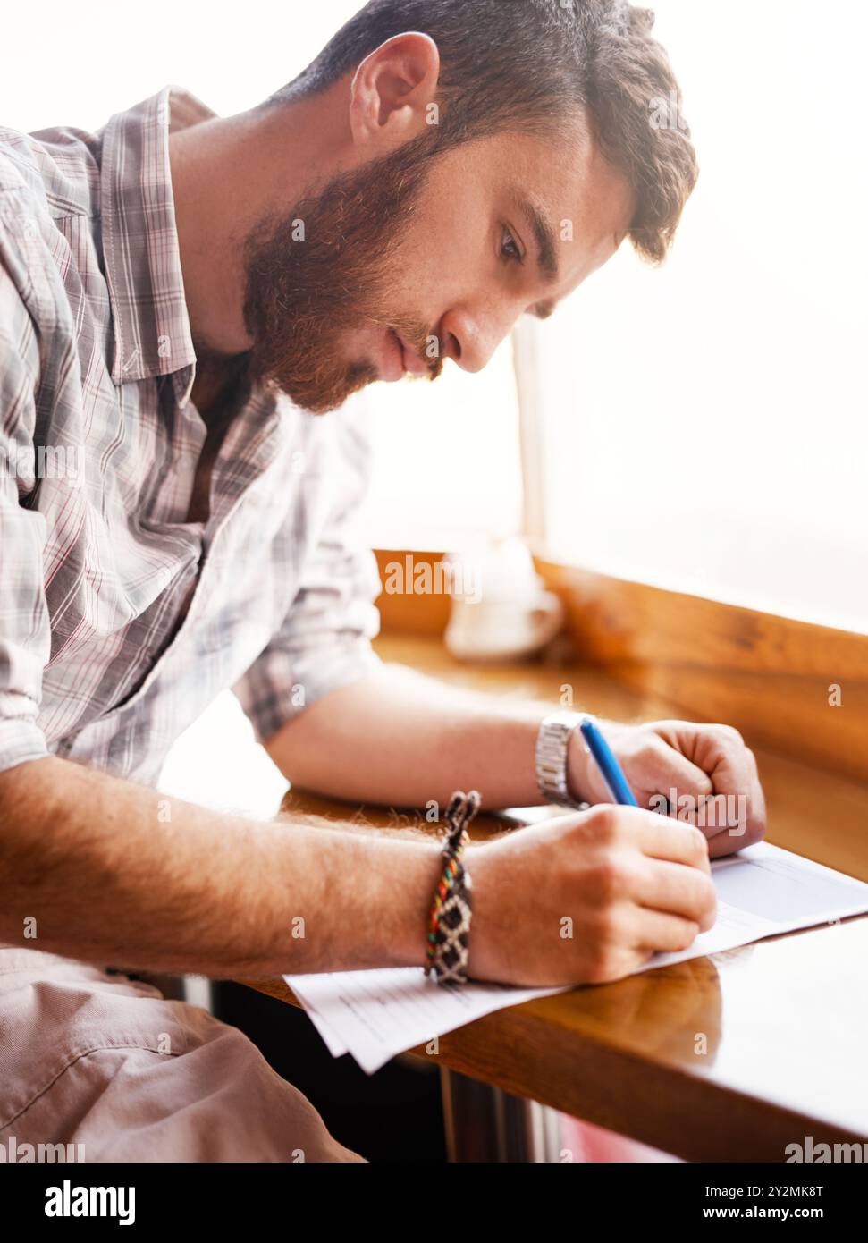 Coffee shop, barista and man writing with documents for menu items ...