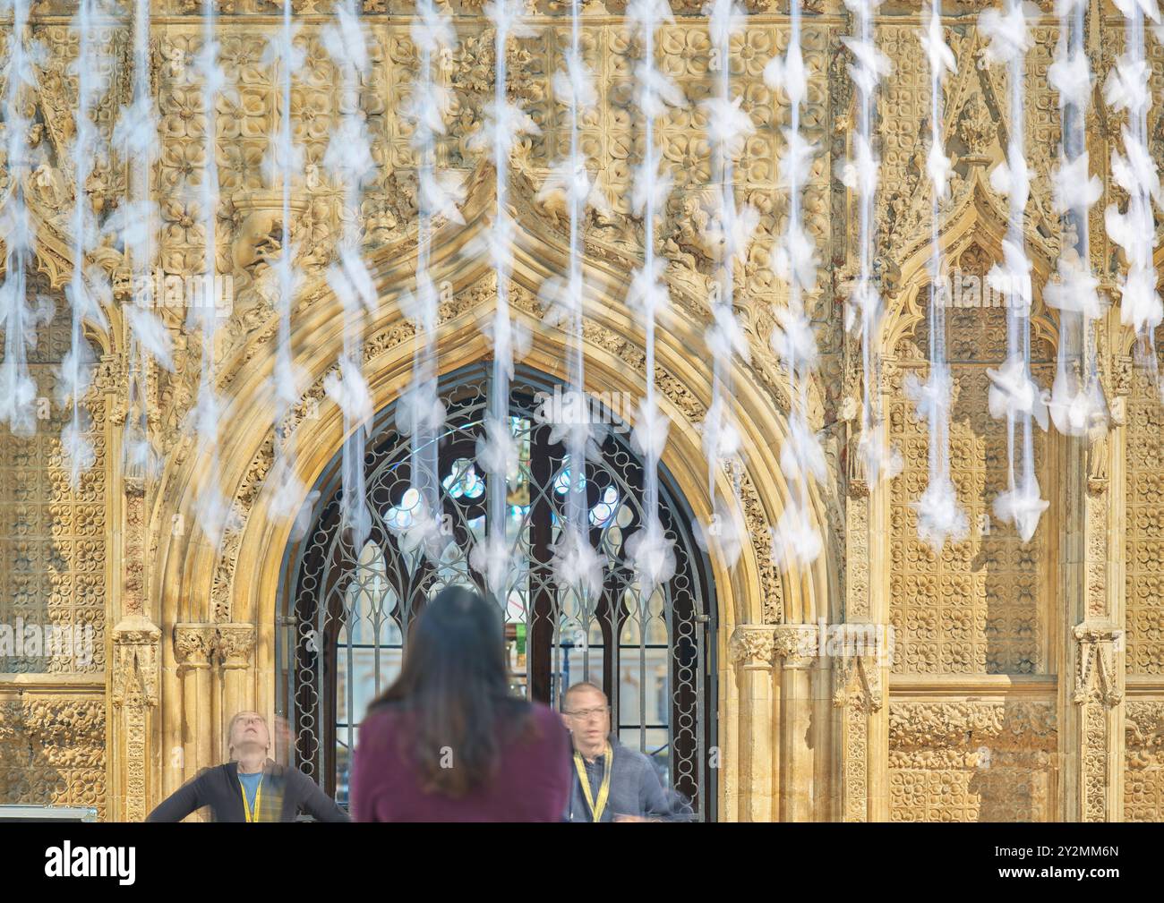 Paper peace doves are raised, on 4 November 2024, in front of the stone ...