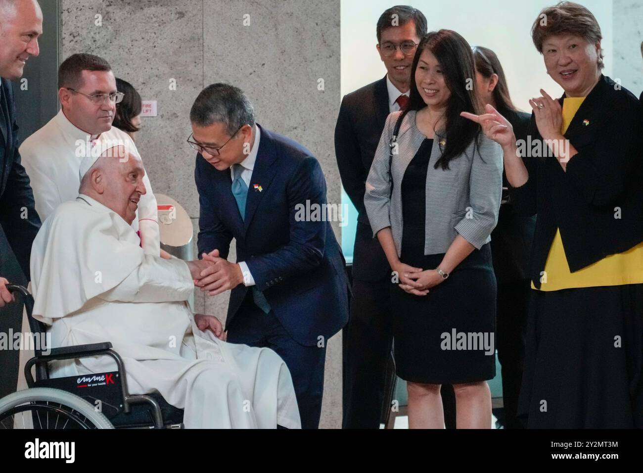 From left, Pope Francis is welcomed by Singapore's Minister of Culture ...