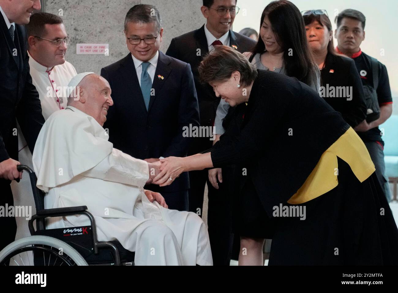 From left, Pope Francis is welcomed by Singapore's Minister of Culture ...