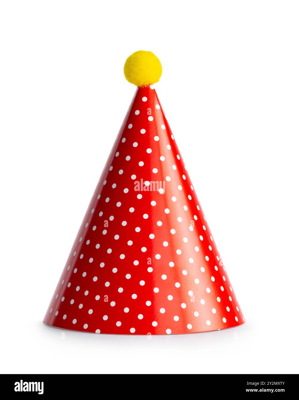Classic red party hat with white polka dots and yellow pompom standing ...