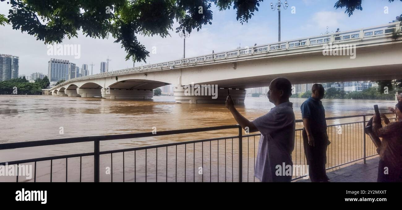 NANNING, CHINA - SEPTEMBER 11, 2024 - Citizens watch flood waters at ...