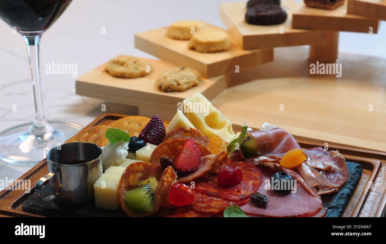 Gourmet charcuterie board with assorted cheeses, meats, fresh fruits ...
