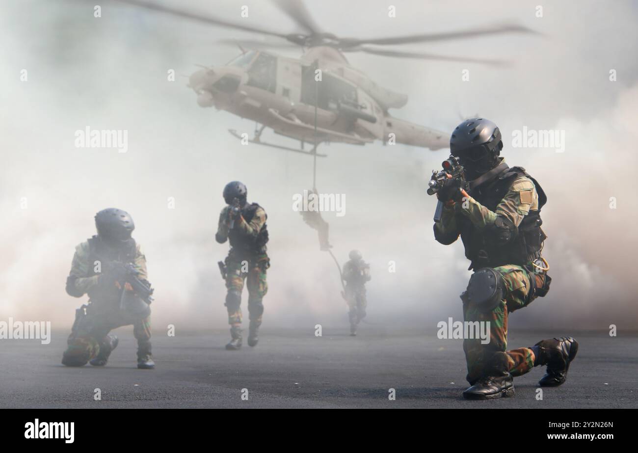 Military special forces unit descend from helicopter and on high alert ...