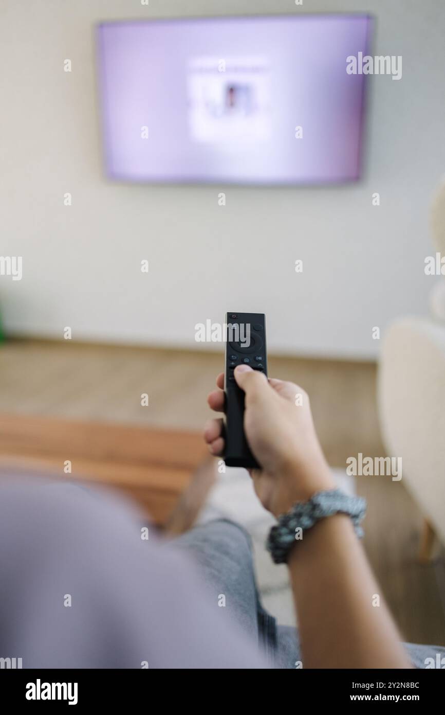 Close-up view of boy hold remote control from tv in right hand Stock ...