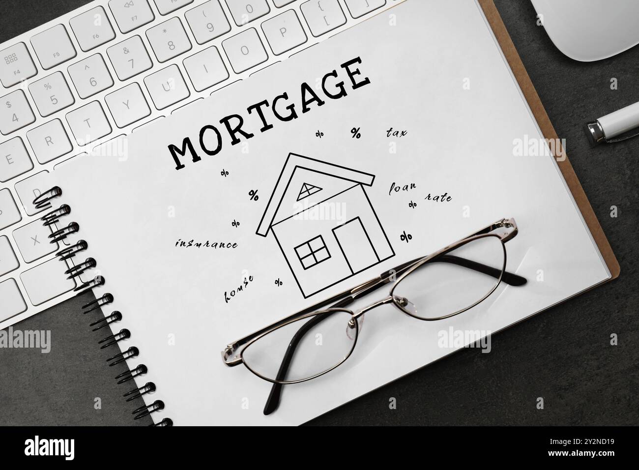 Mortgage. Notebook with drawing of house, percent signs and words on ...