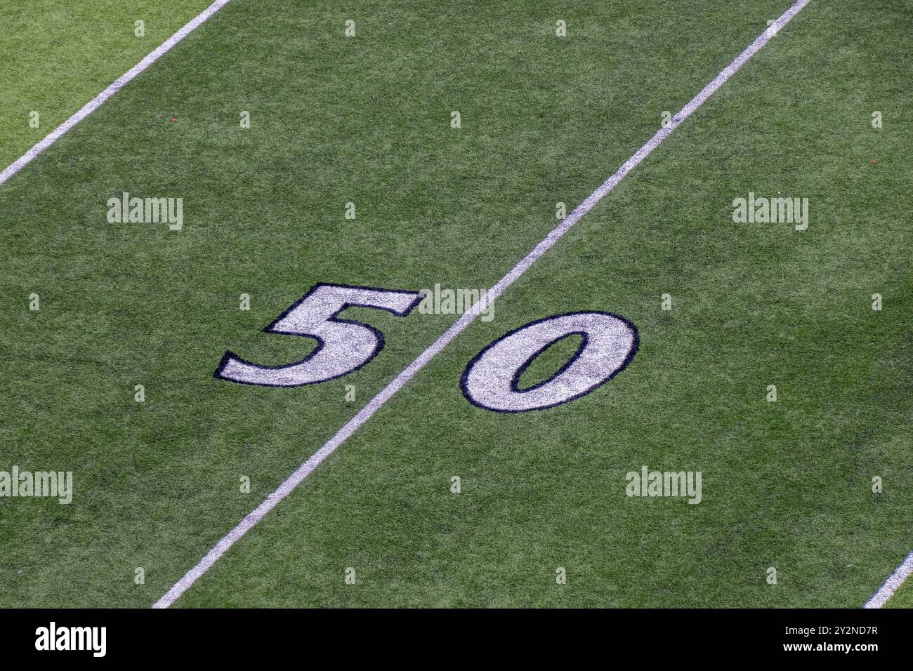 An American football field detail of white chalk drawn lines. midfield ...
