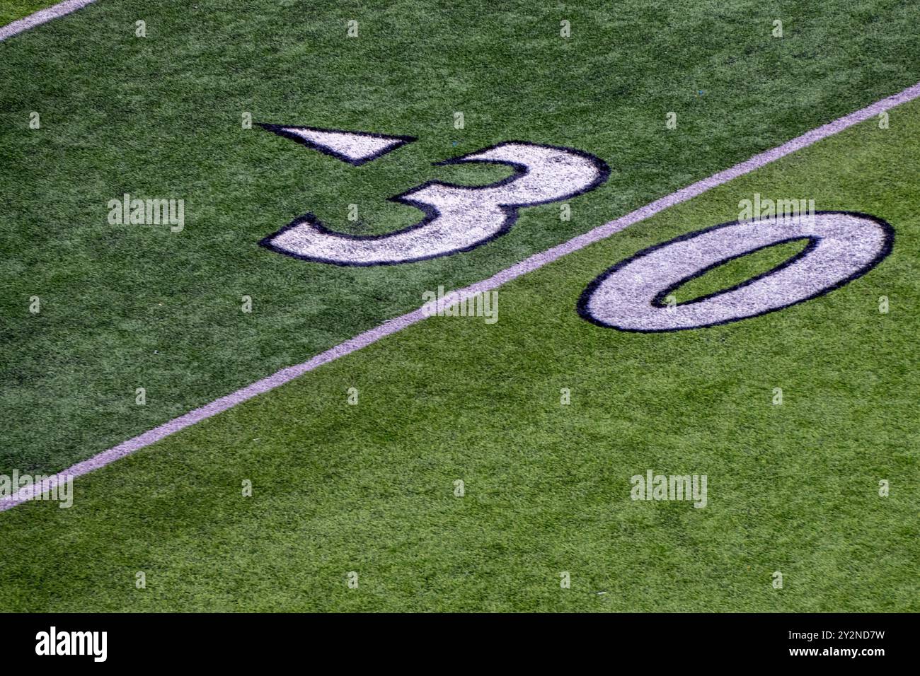 An American football field detail of white chalk drawn lines. 30 yards ...