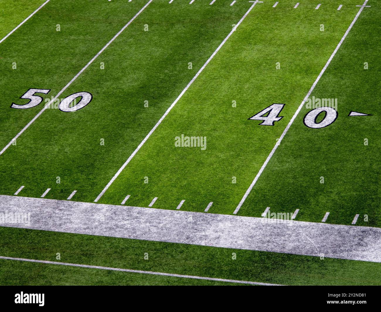 An American football field detail of white chalk drawn lines. 50 and 40 ...