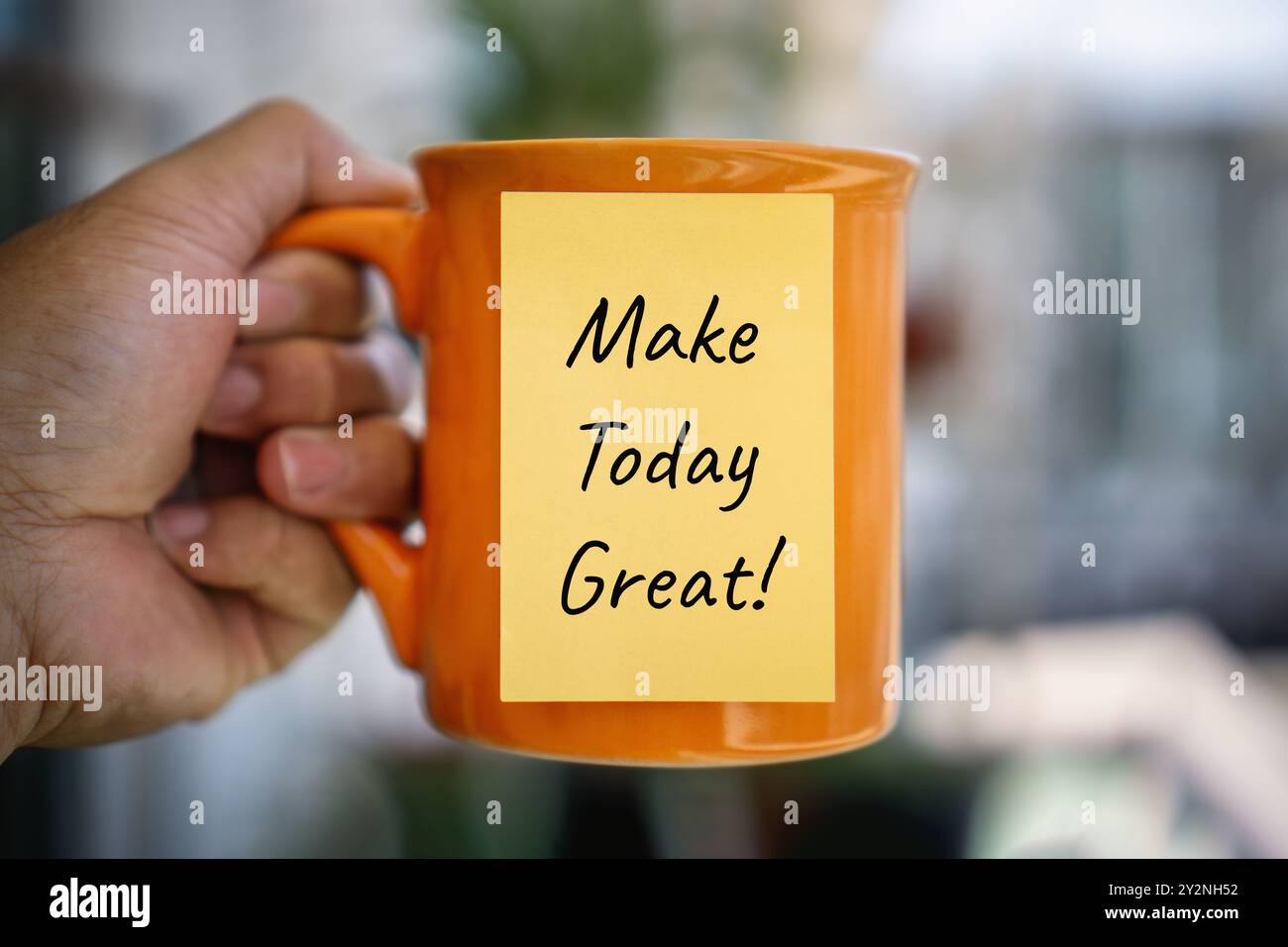 Close-up photo of an orange coffee mug with an inspirational message on ...