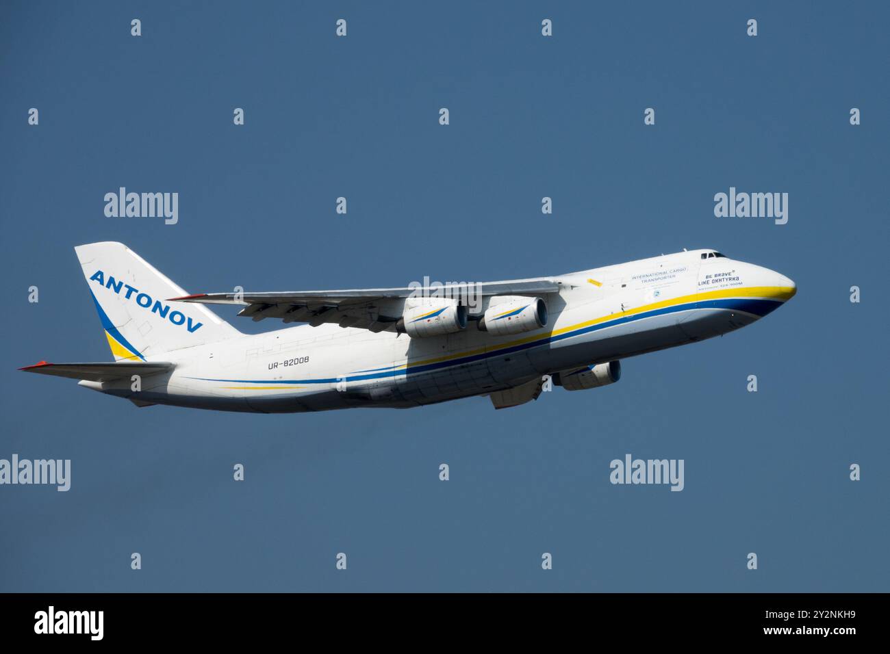 Plane Antonov 124 100M cargo aircraft in flight against a clear blue ...