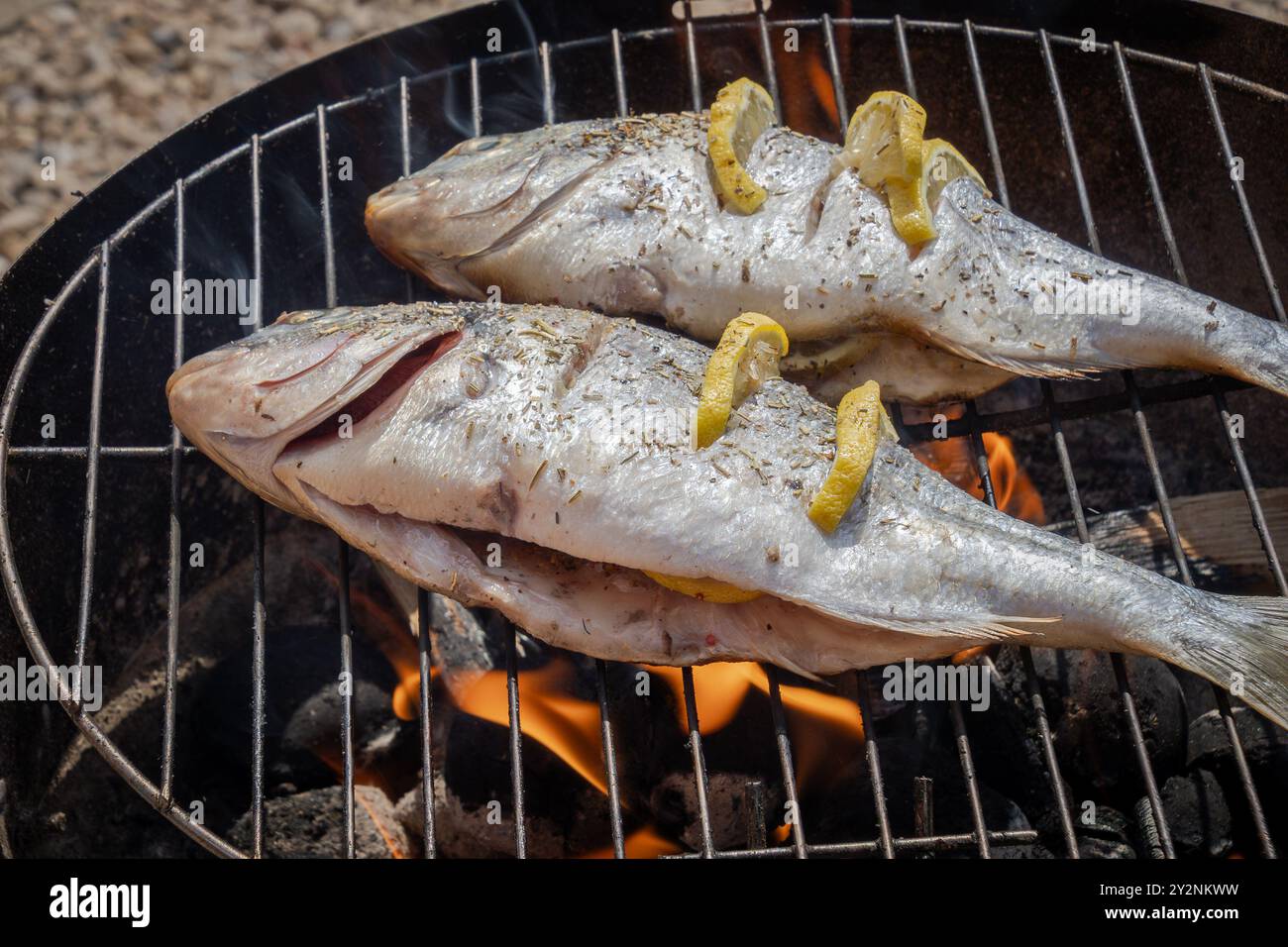 cooking two fish, sea bream on the barbecue Stock Photo - Alamy