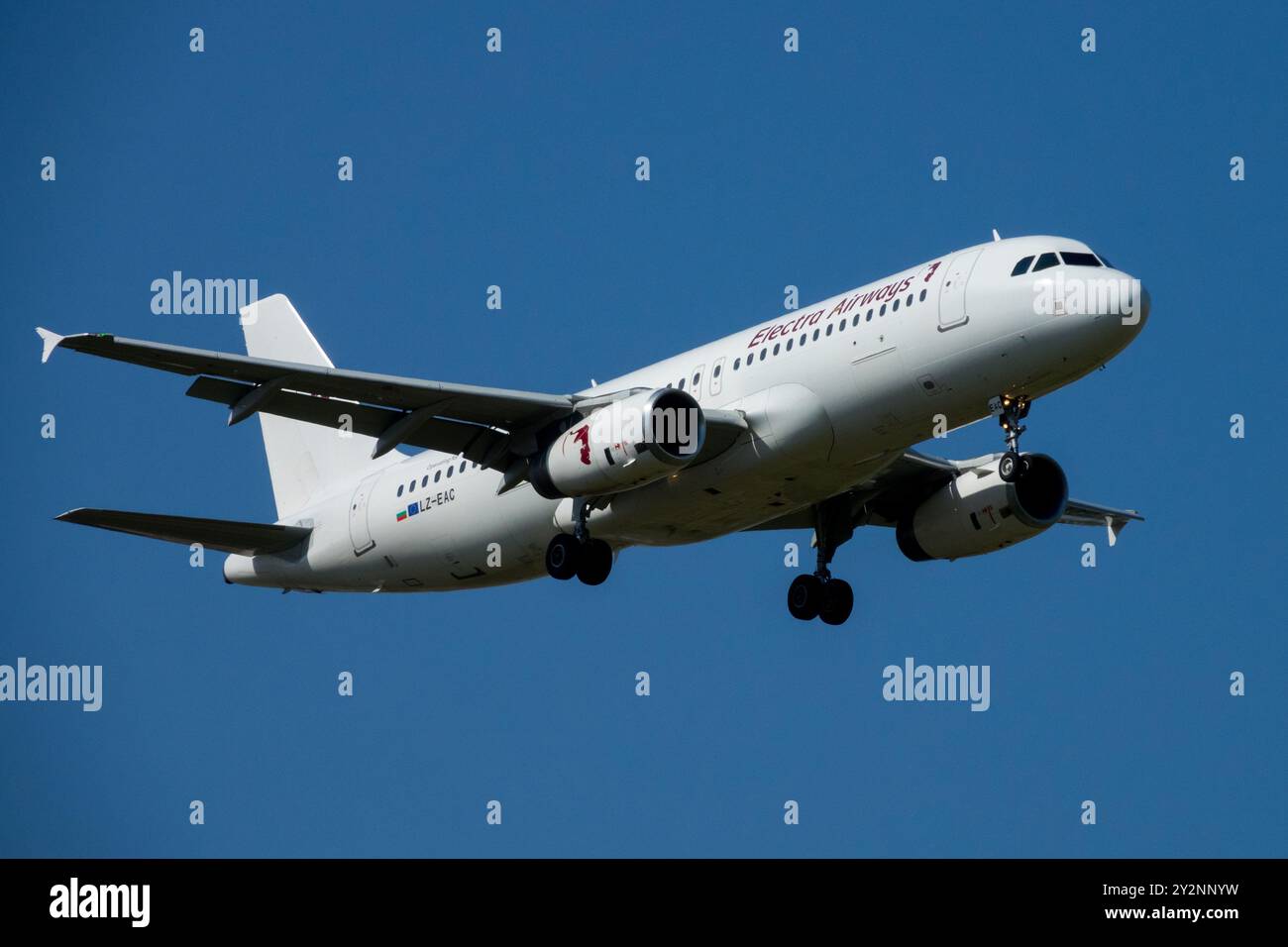 Passenger airplane Electra Airways flying in the clear blue sky with ...