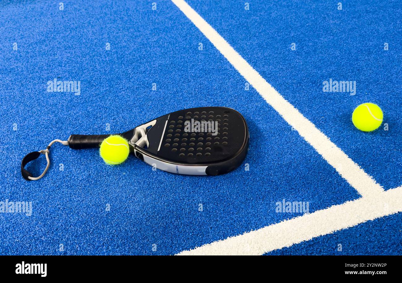 padel racket on a padel blue court with a ball Stock Photo - Alamy