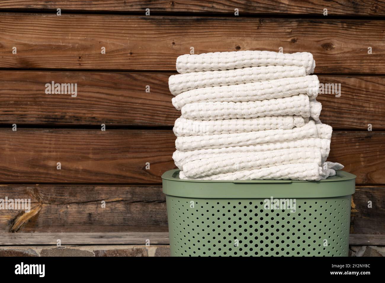 stack of clean white towels on a laundry basket Stock Photo - Alamy