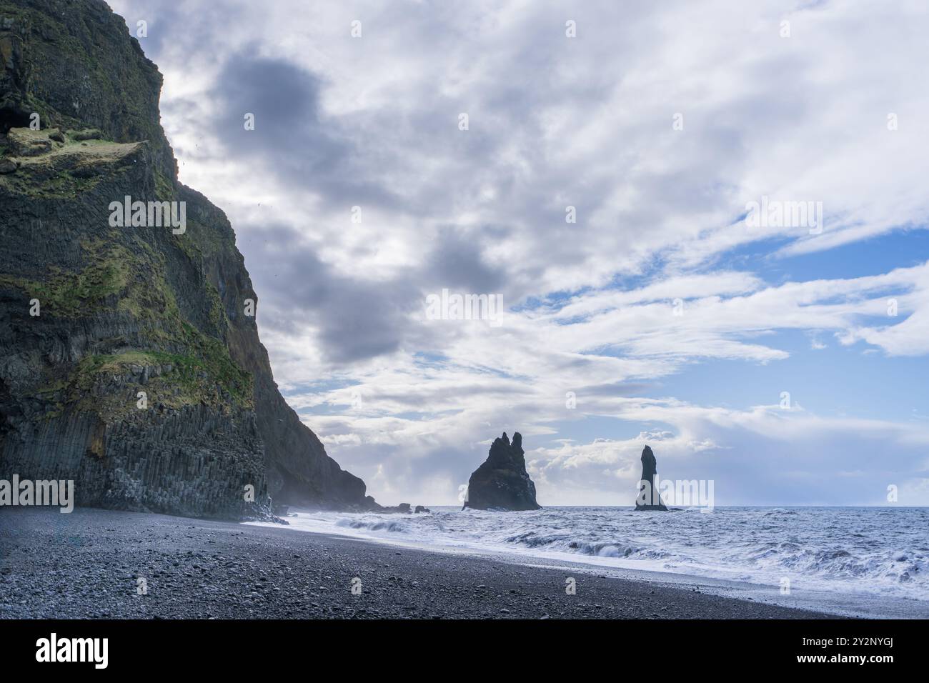 The iconic Reynisdrangar sea stacks rise dramatically from the black ...
