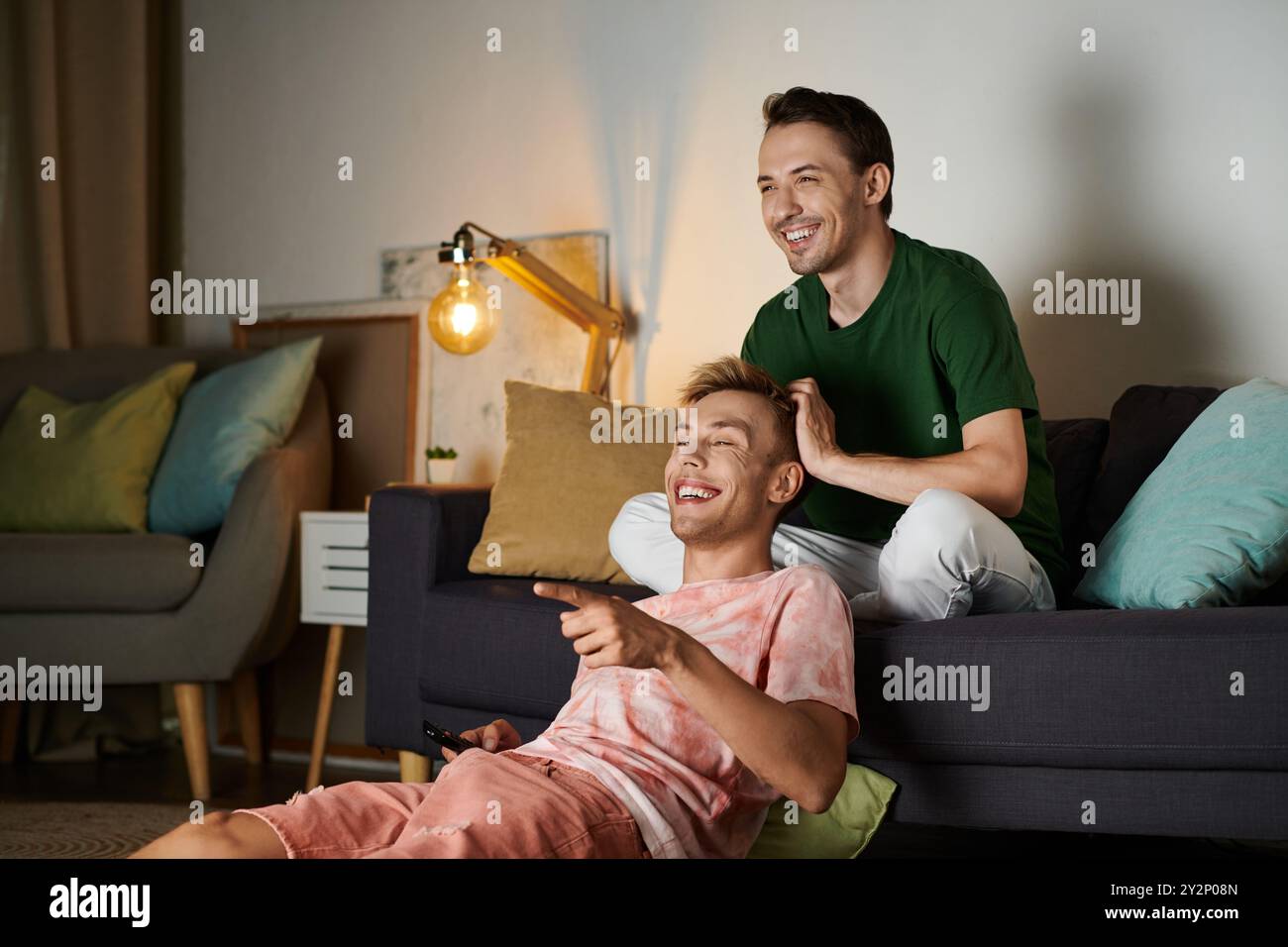 Two men enjoy their cozy evening, sharing laughter and warmth together ...