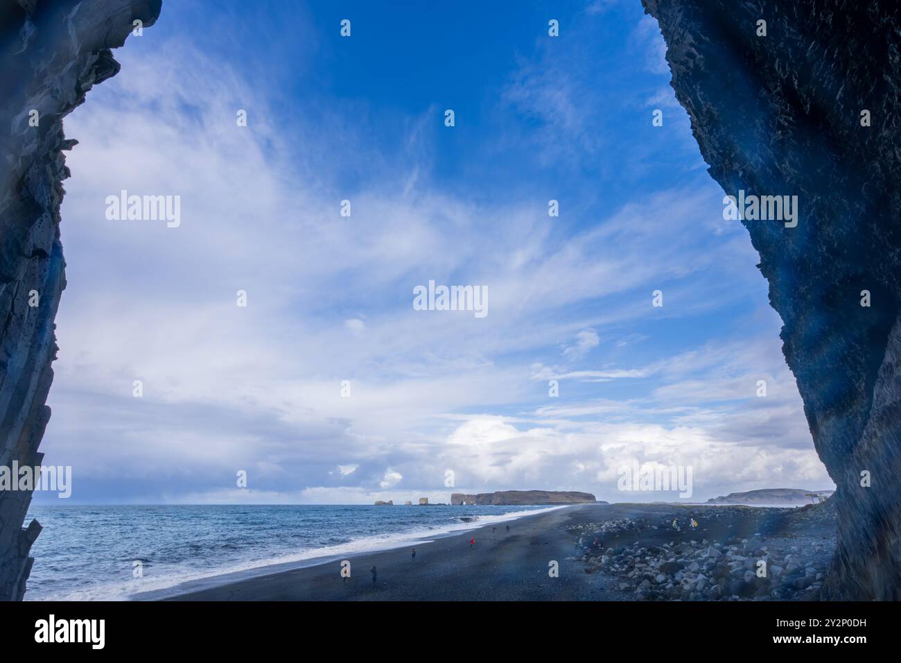 The iconic Reynisdrangar sea stacks rise dramatically from the black ...
