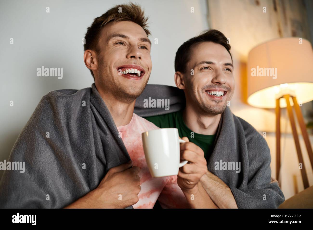 Two men share a warm moment together, smiling and enjoying each other ...