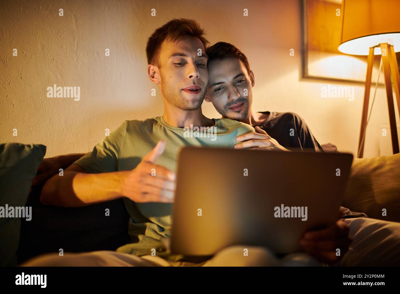 Two men enjoy a cozy moment together, sharing smiles and comfort Stock ...