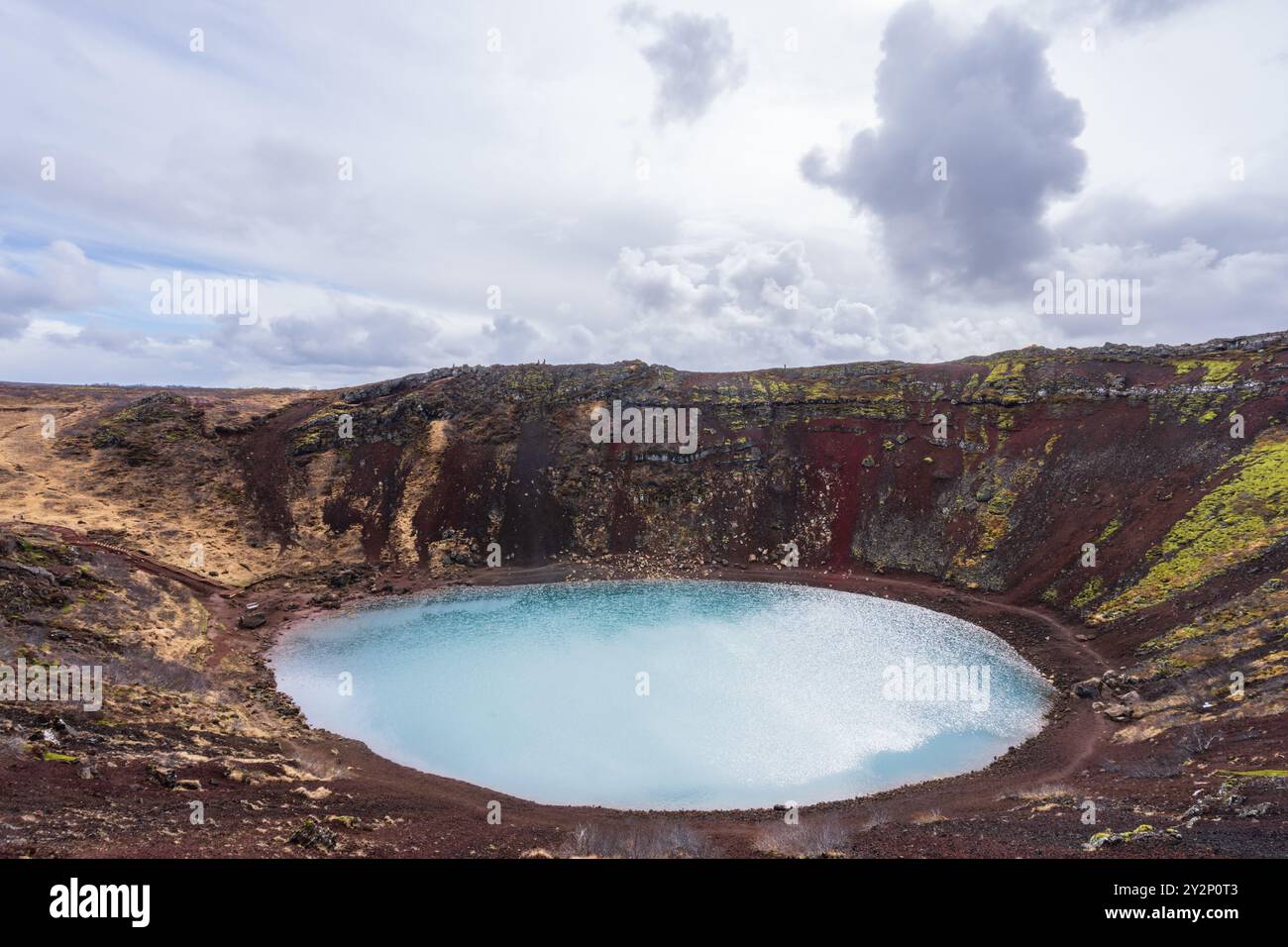 A serene view of Kerid Crater, a volcanic caldera in Iceland. The deep ...
