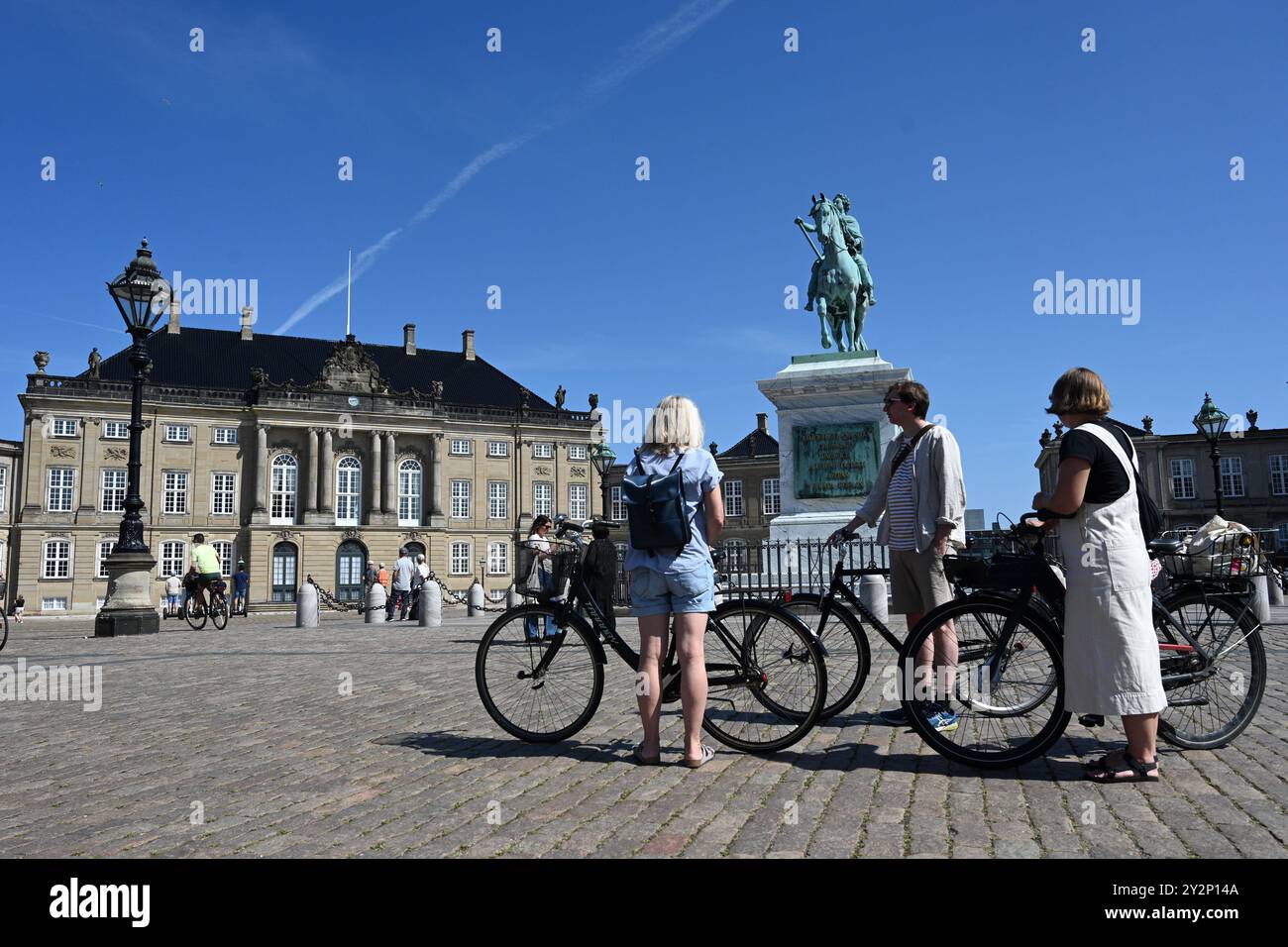 Copenhagen, Denmark - August 1, 2024: A cyclists near the Amalienborg ...