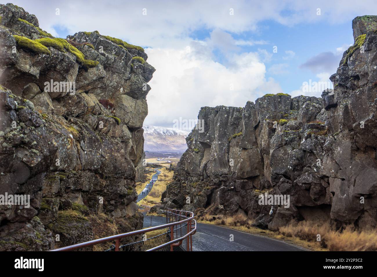 A hiker walks along a trail in Thingvellir National Park, Iceland, with ...