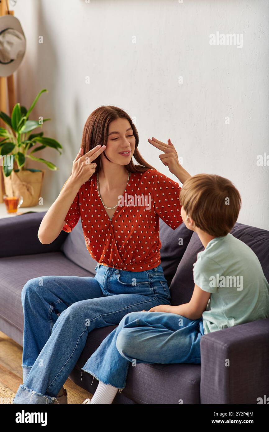 A mother uses sign language to communicate with her young son Stock ...