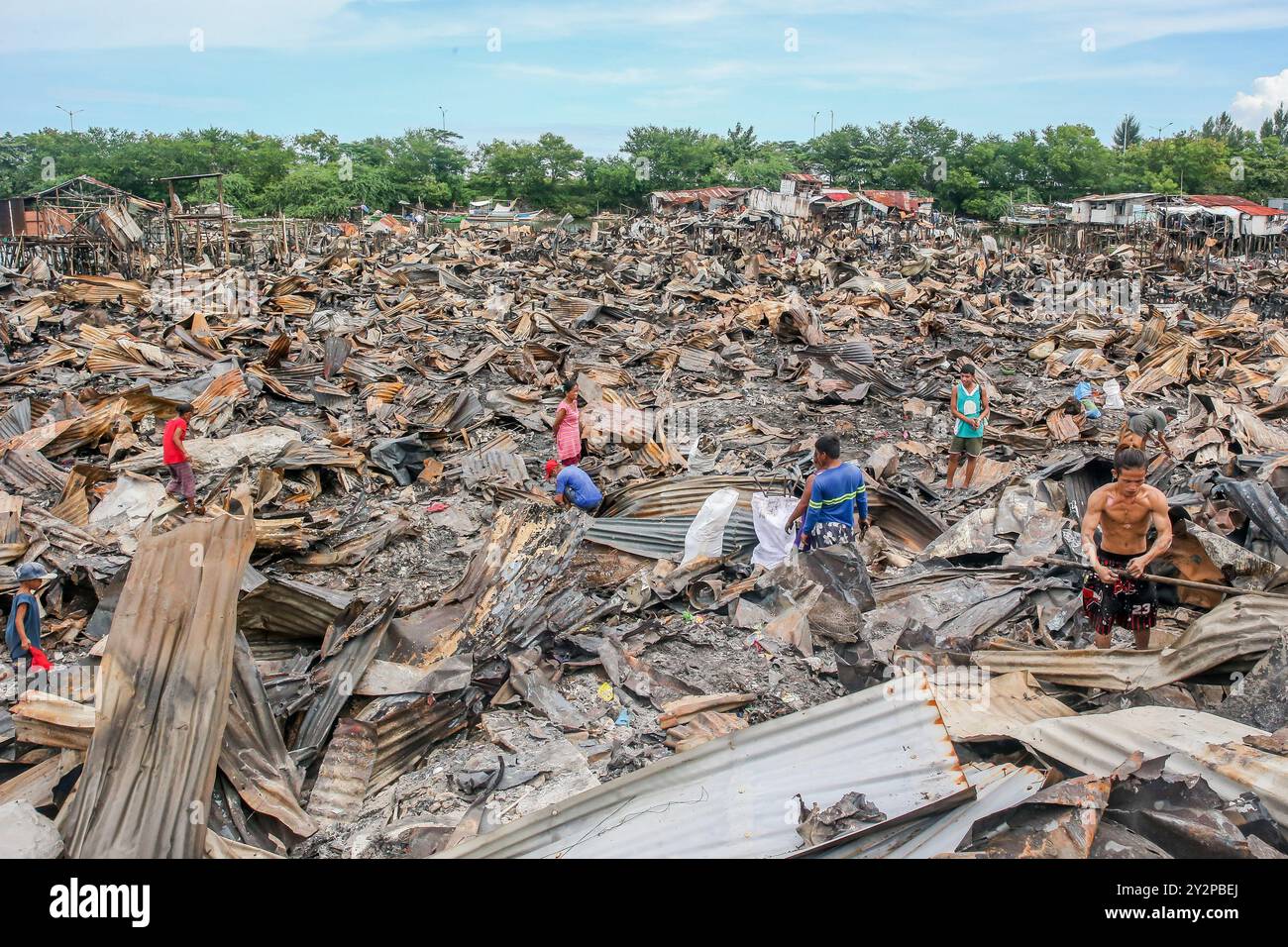 Cavite Province. 11th Sep, 2024. Residents search for useful stuff as ...