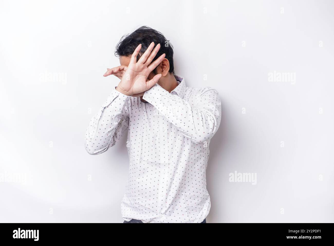 Young scared Asian man isolated on white background, looks depressed ...