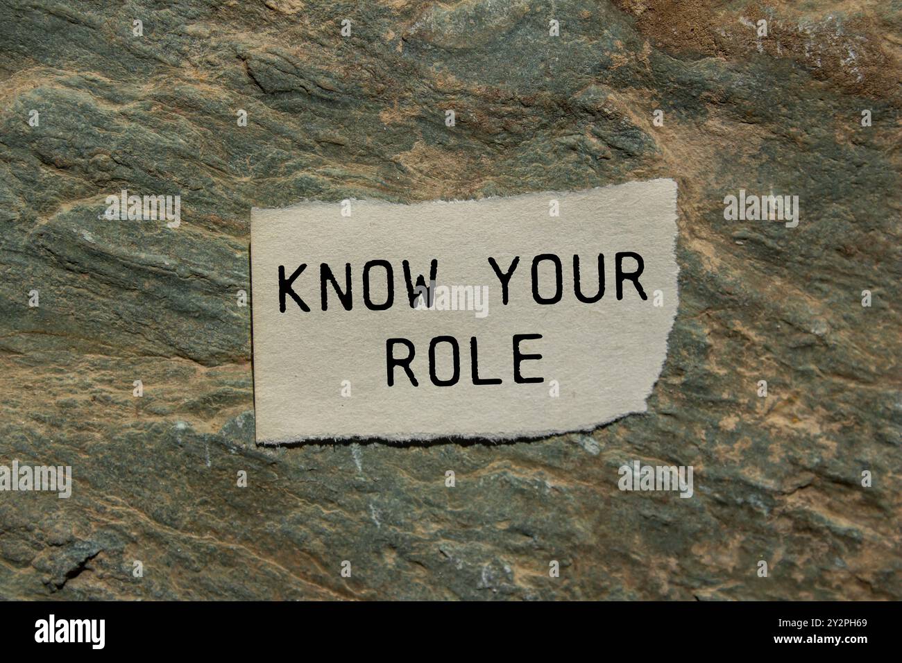 Know your role message written on ripped torn paper piece on stone ...