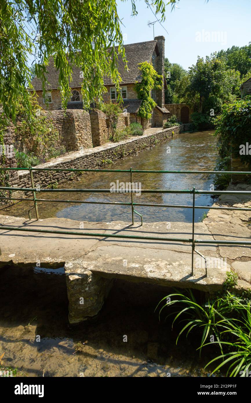 The River Bride flowing through the village of Burton Bradstock, Dorset ...
