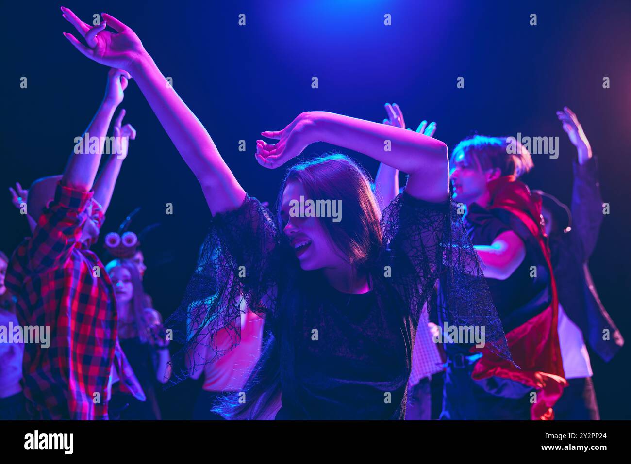 Halloween party scene with cheerful young boys and girls, students ...