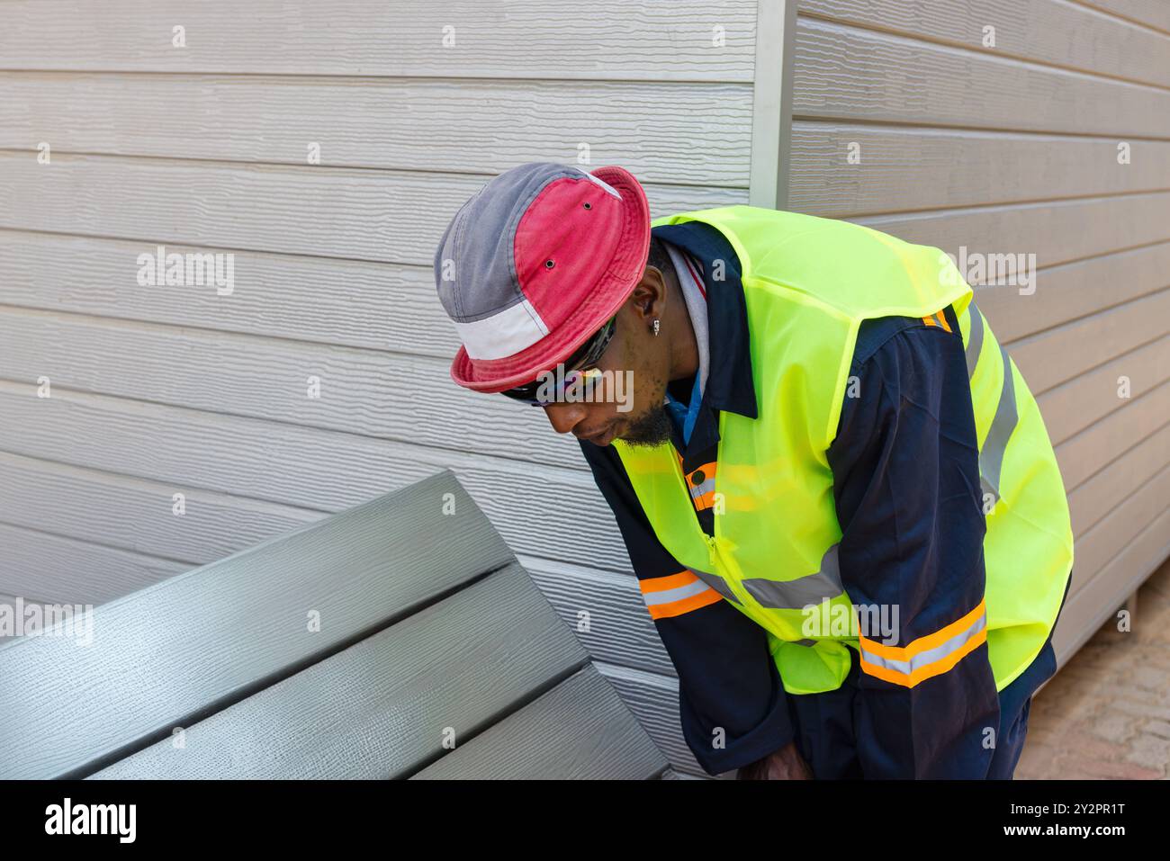african worker with a big smile and a gold tooth wearing sunglasses and ...