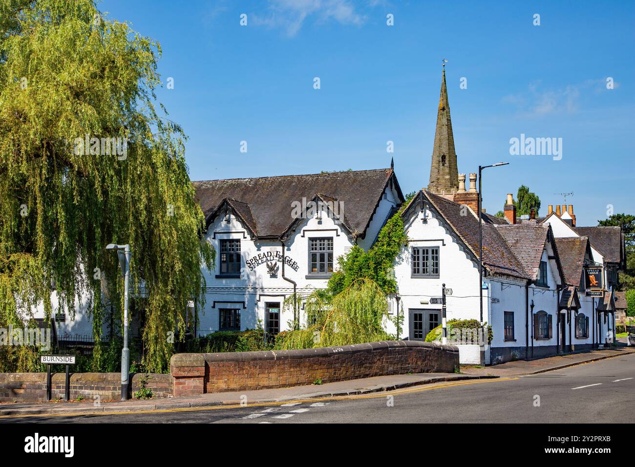 The Spread Eagle pub and the spire of St Mary's Church on the banks of ...