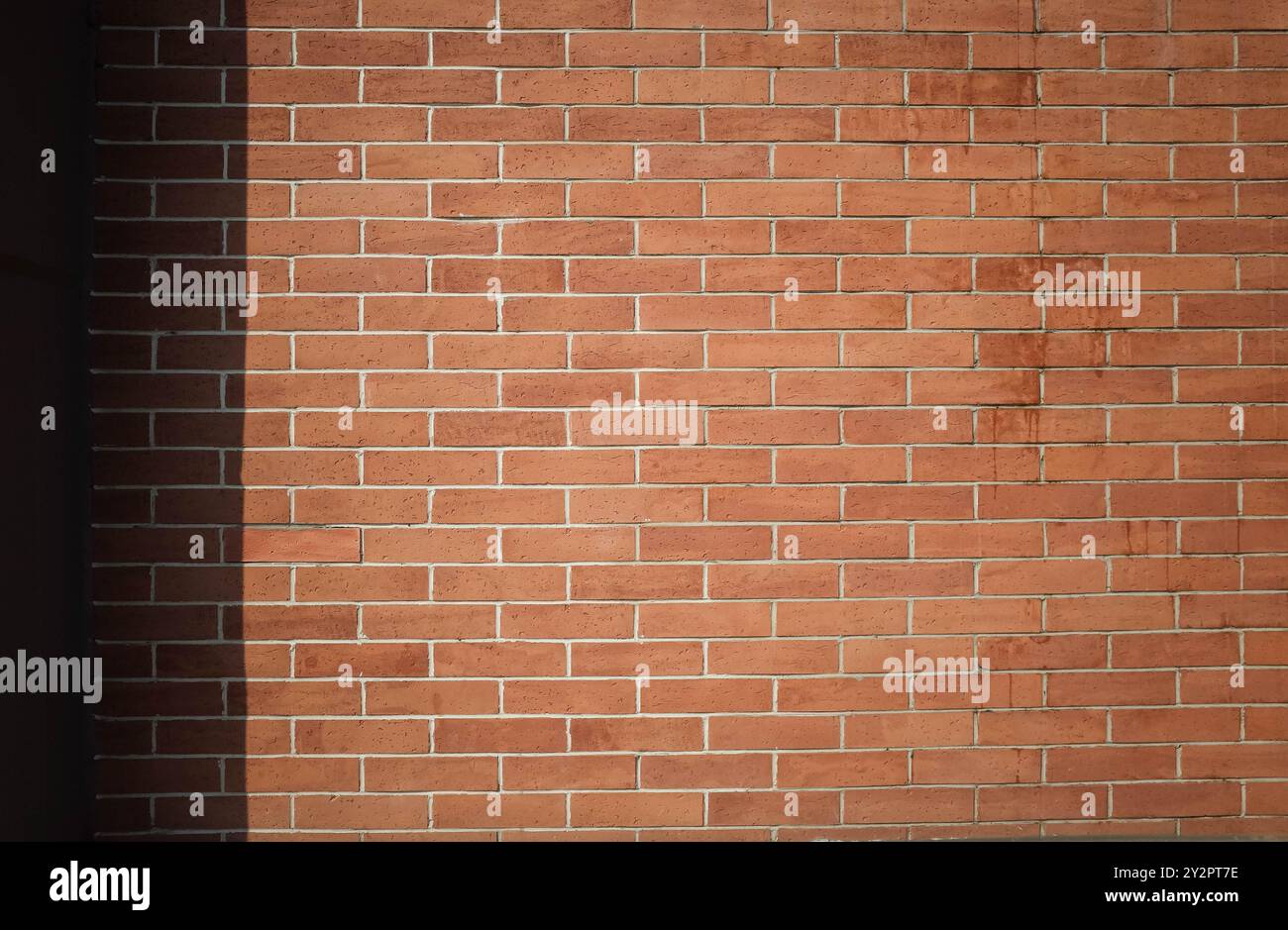 Red brick wall summer background with shadows. Brick wall copy space ...
