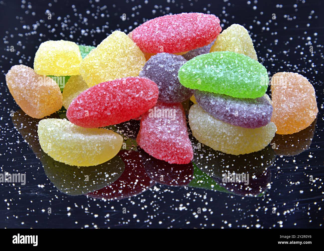 Pile of sugary sweets on black background Stock Photo - Alamy