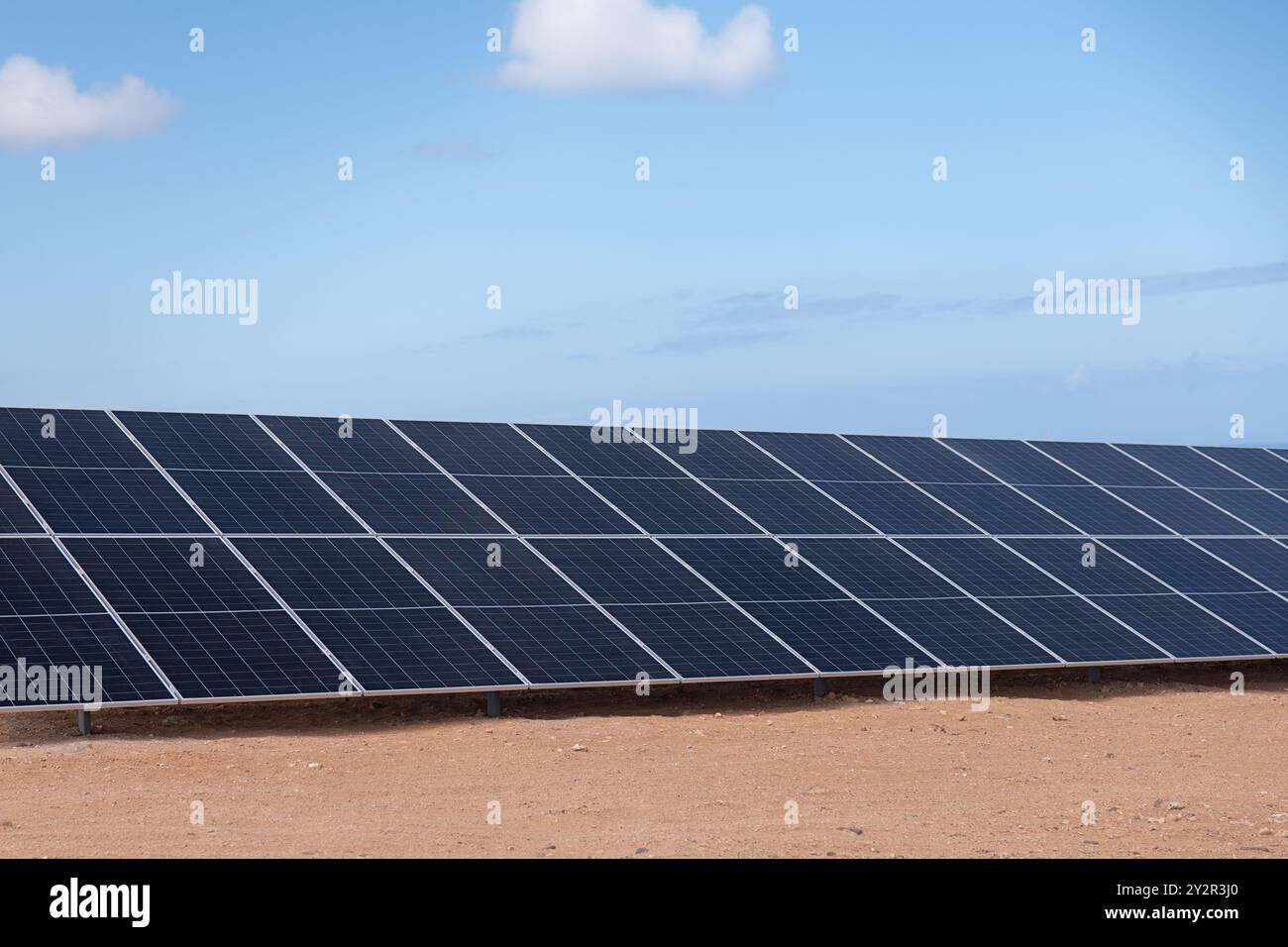 Extensive array of solar panels installed in a dry, open landscape ...