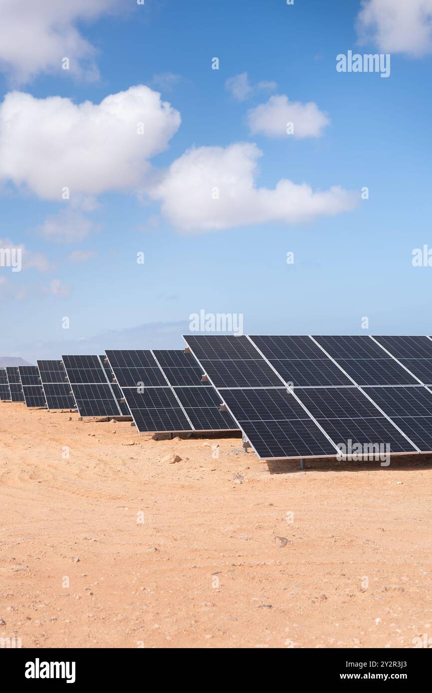A seamless alignment of solar panels stretches across a barren desert ...