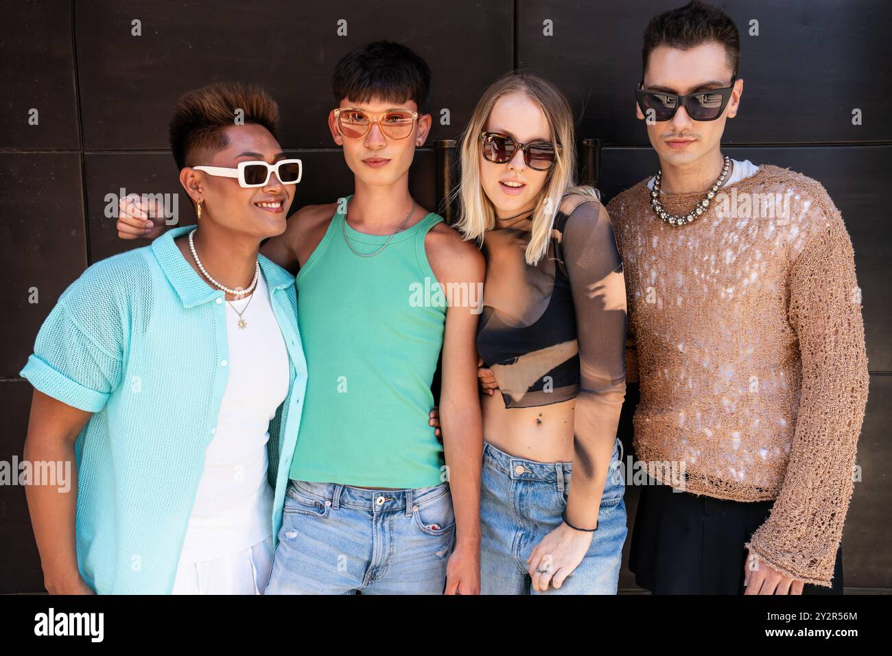 A group of LGBTQIA+ friends stand together, showcasing diversity and ...