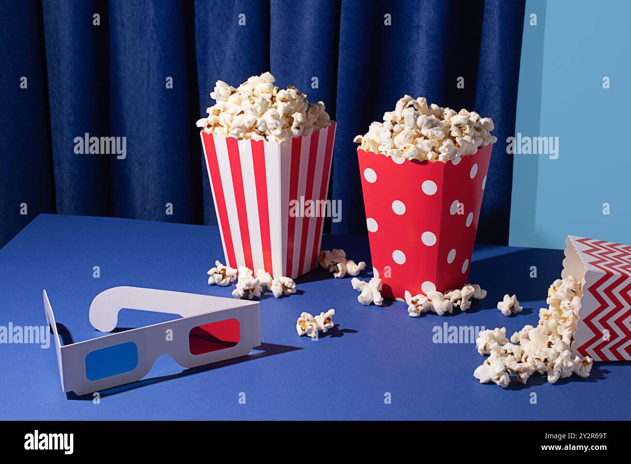 Classic striped bucket overflowing with buttery popcorn hi-res stock ...