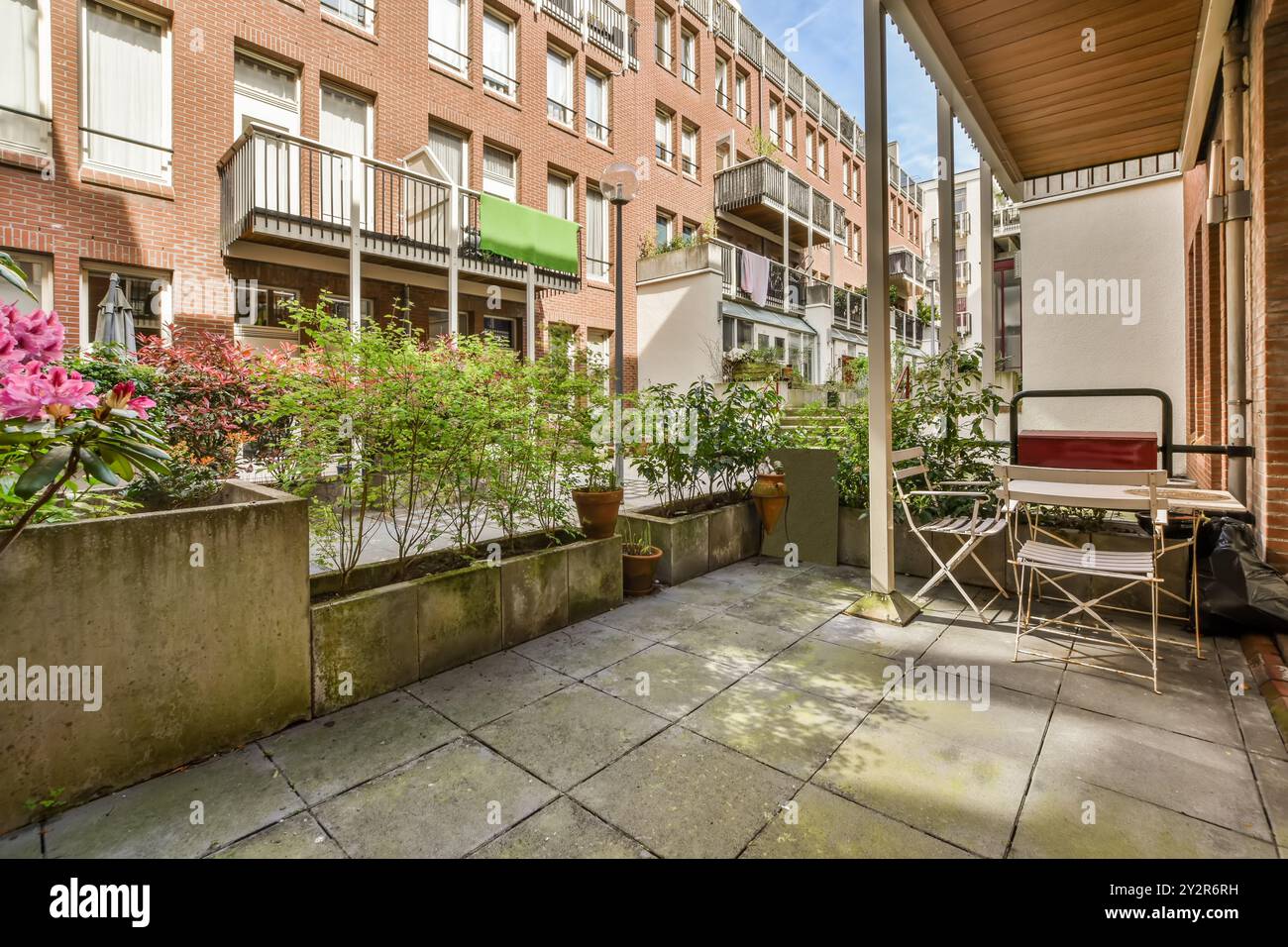 A peaceful apartment terrace featuring lush plants, flowers, and a ...
