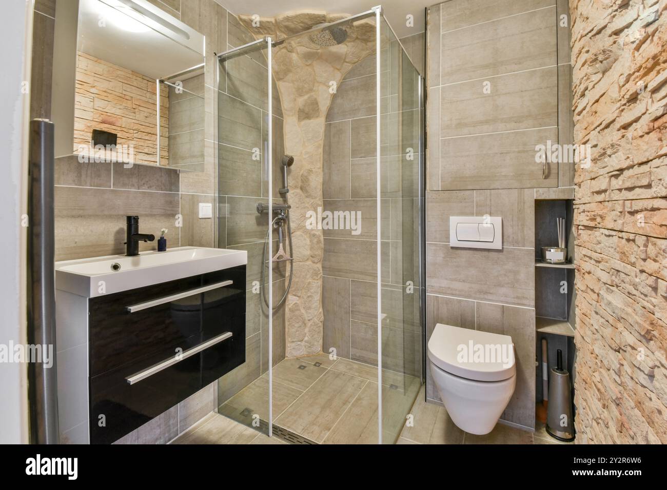 Contemporary styled bathroom featuring a glass shower cubicle, sleek ...