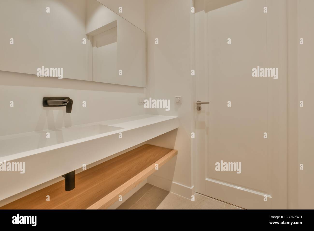 A contemporary bathroom featuring a sleek floating vanity, wall-mounted ...