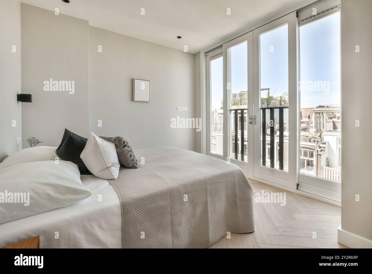 A spacious modern bedroom featuring a large comfortable bed, minimalist ...