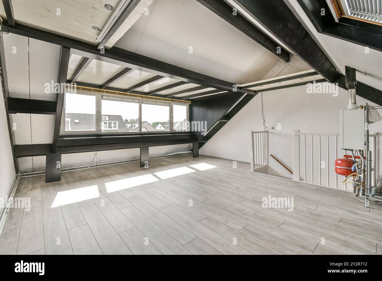 An attractive, empty attic space with exposed wooden beams, large ...