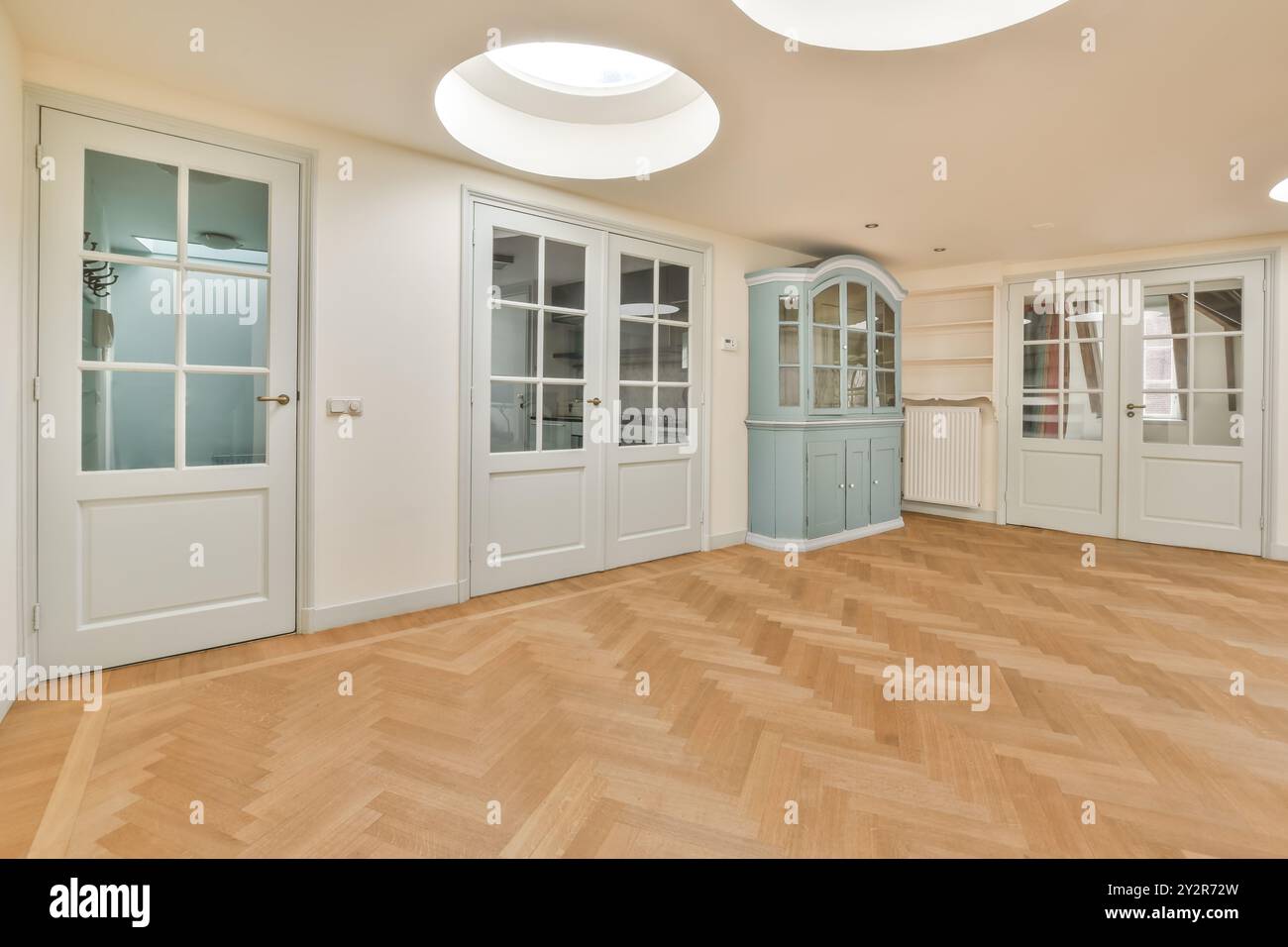 Elegant interior of a spacious room featuring herringbone parquet ...