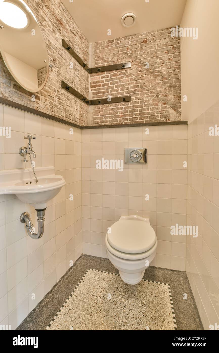 A stylish bathroom featuring a classic white toilet, sink, and modern ...